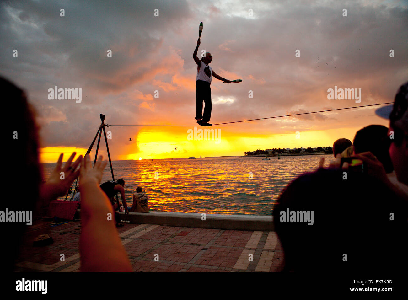 Street performer Will Soto performs his tightrope act during the Sunset ...