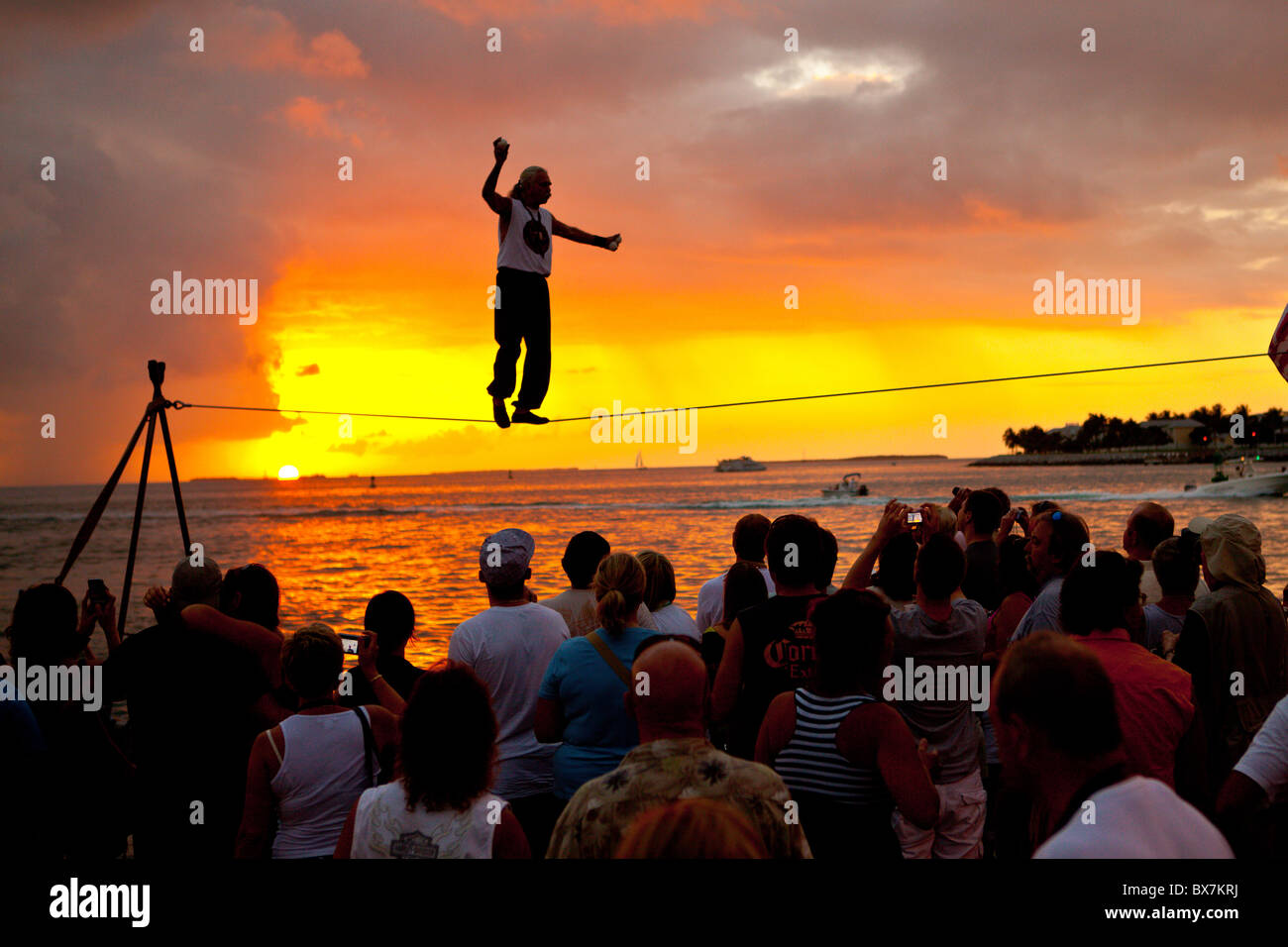 Street performer Will Soto performs his tightrope act during the Sunset ...