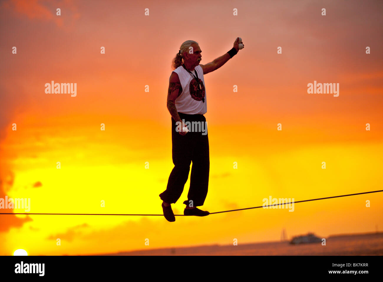 Street performer Will Soto performs his tightrope act during the Sunset ...