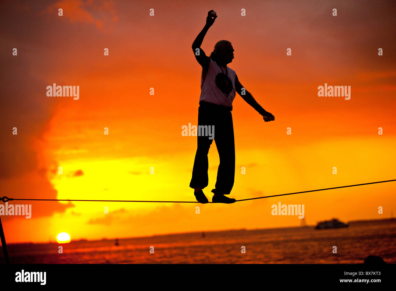 Street performer Will Soto performs his tightrope act during the Sunset ...