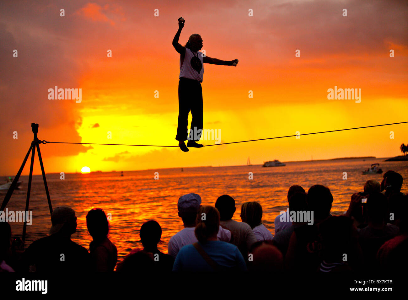 Street performer Will Soto performs his tightrope act during the Sunset ...