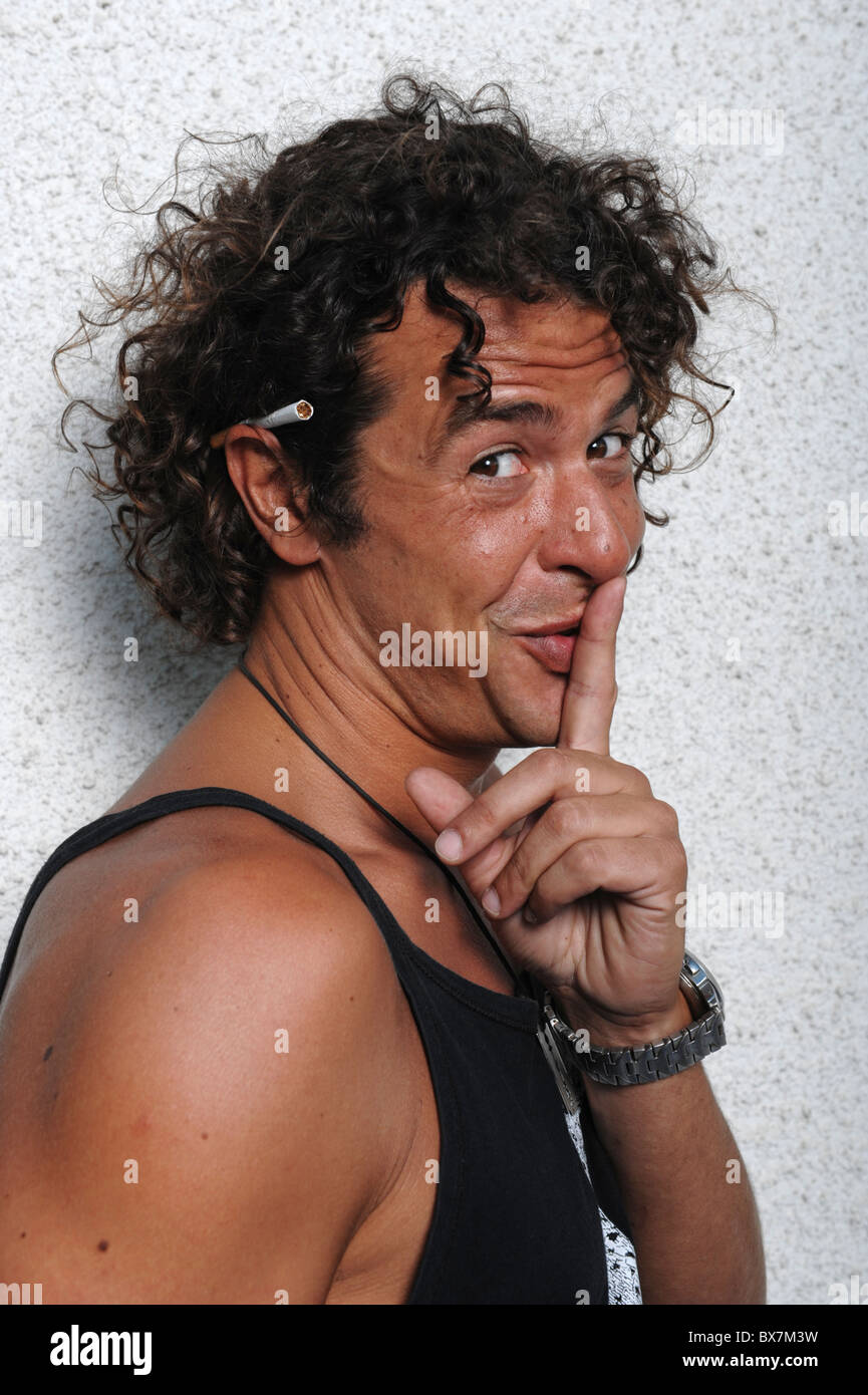 Portrait of man making shushing gesture Stock Photo - Alamy