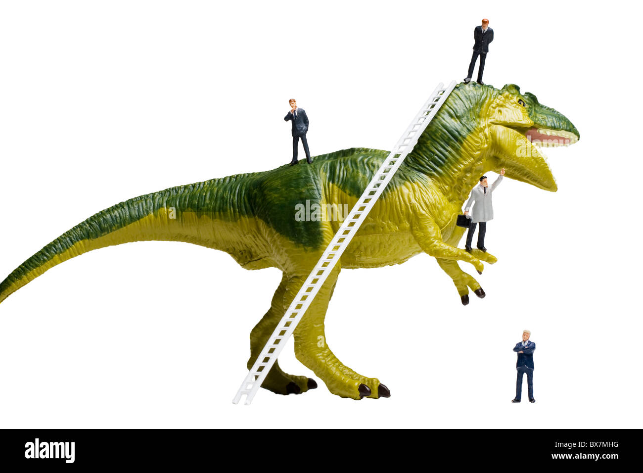 Business figurines and a small ladder placed on a dinosaur figurine ...