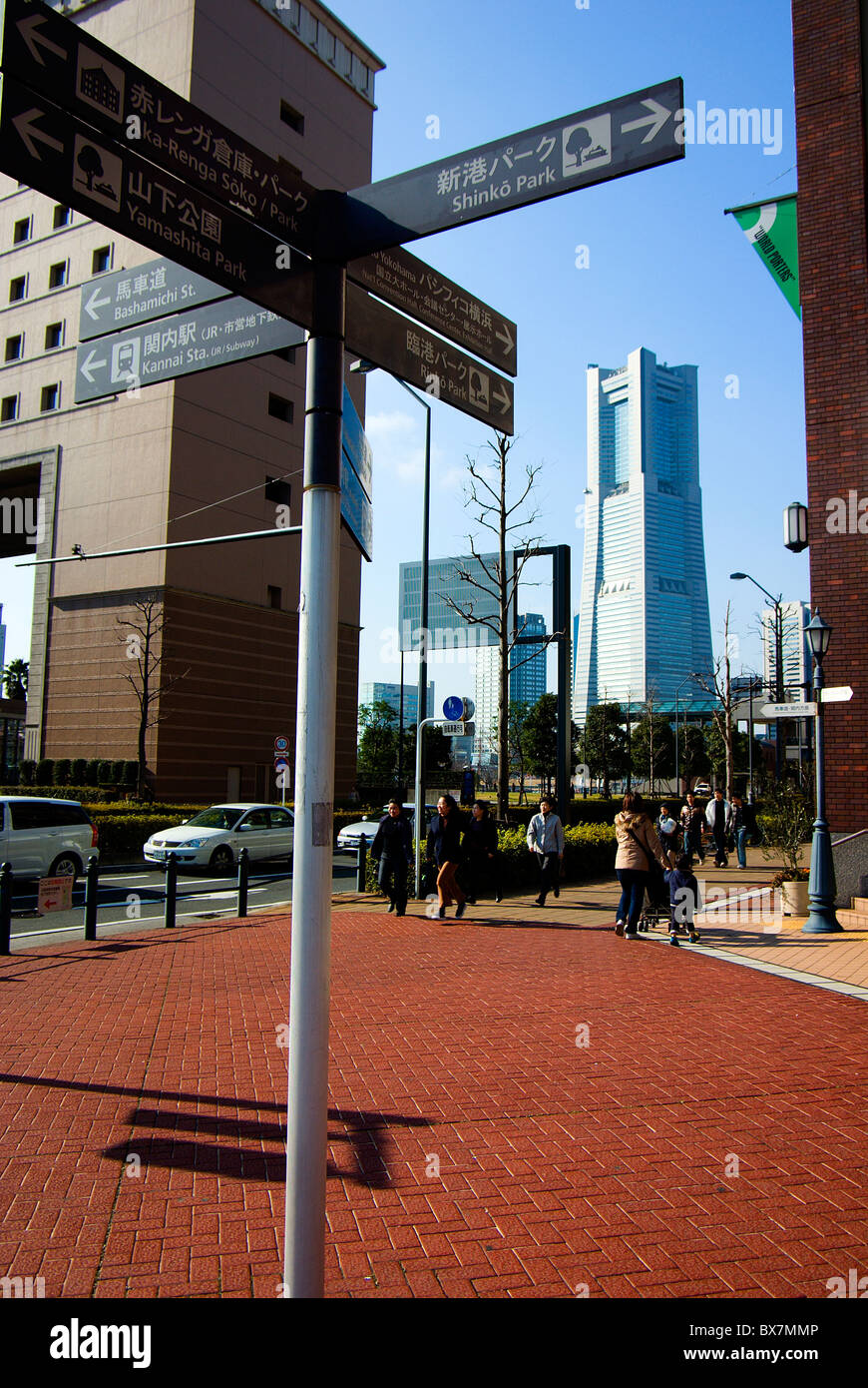 traffic sign in yokohama, japan, with landmark tower in the background ...
