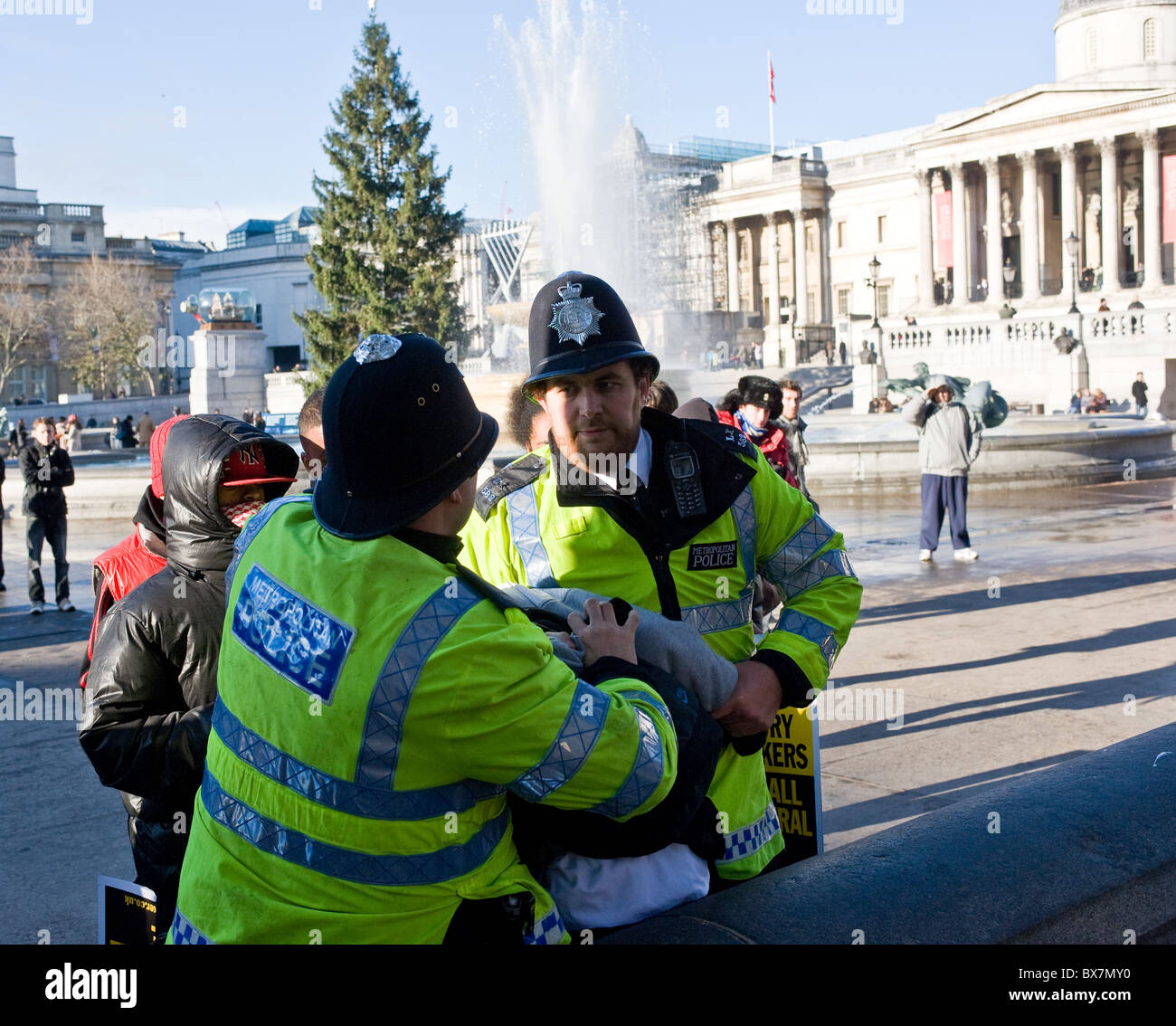 Metropolitan Police officers detain a young person in Trafalgar Square ...