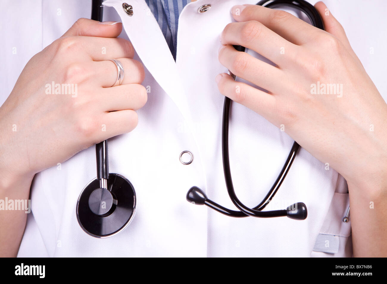 Nurse or doctor holding stethoscope in white scrubs Stock Photo - Alamy