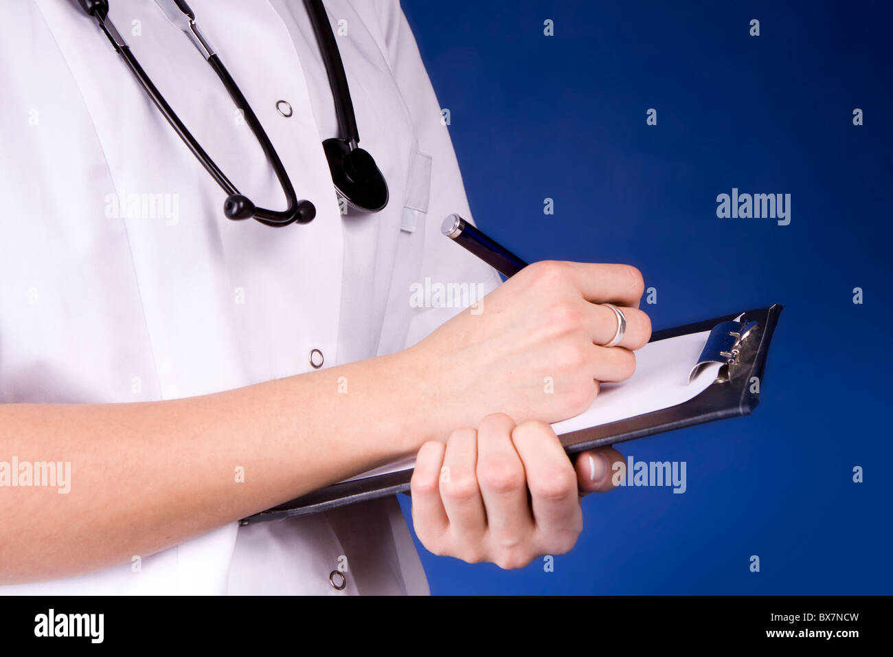 Healthcare professional, doctor or nurse, writing with a fountain pen ...