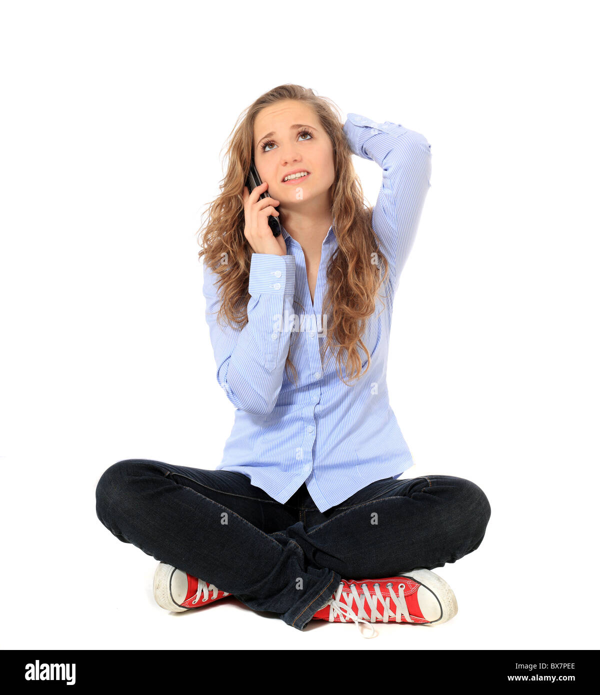 Attractive young girl making a phone call. All on white background ...