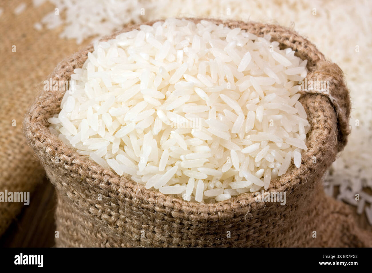 White long rice in small burlap sack Stock Photo - Alamy