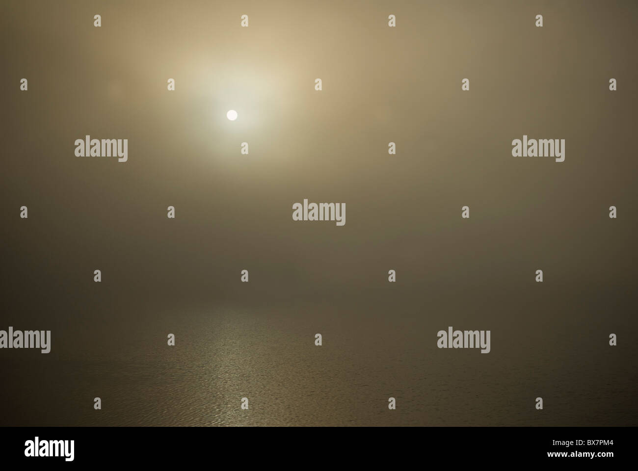 Weak sun through mist, Lake Windermere, Lake District National Park ...