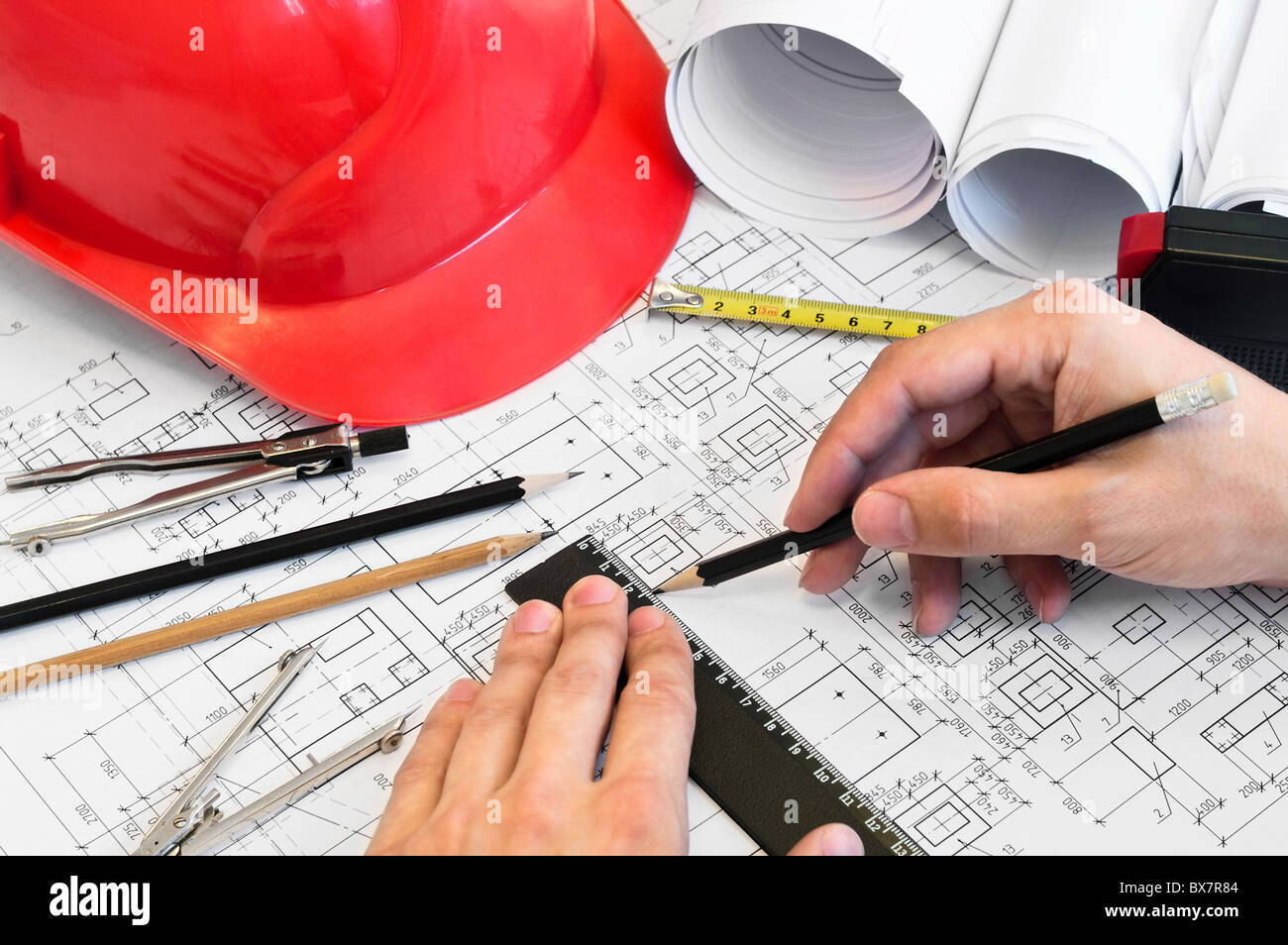 Design drawings and human hands drawing a project by pencil on paper ...