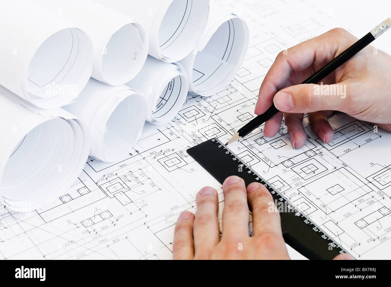 Design drawings and human hands drawing a project by pencil on paper ...