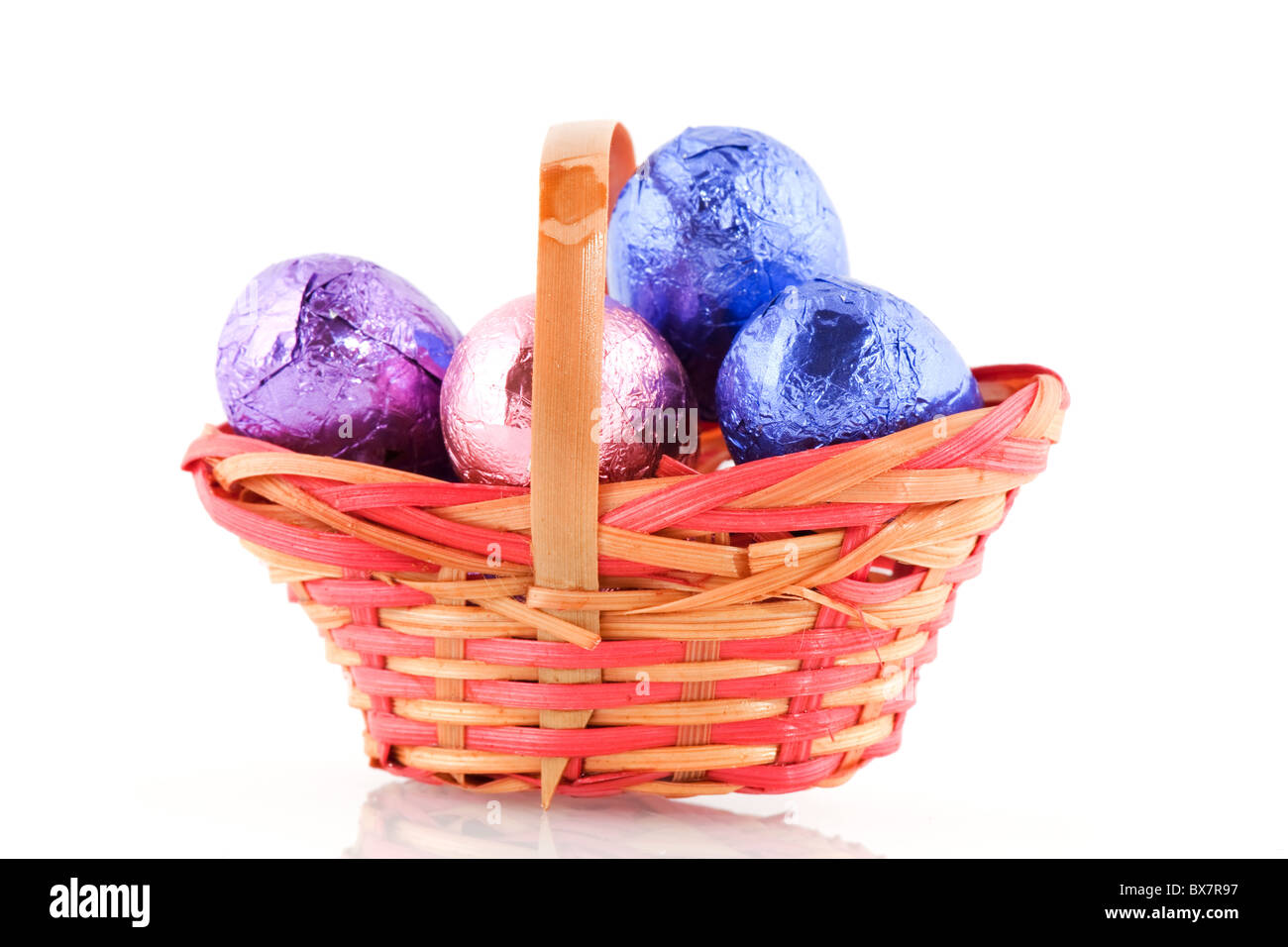 easter basket filled with chocolate eggs isolated over white Stock ...