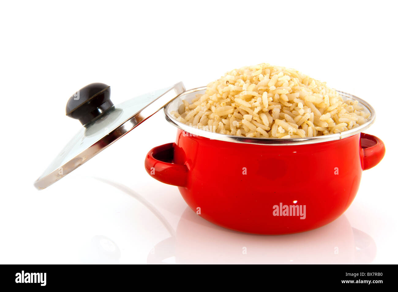 Red pan with healthy brown rice isolated over white Stock Photo - Alamy