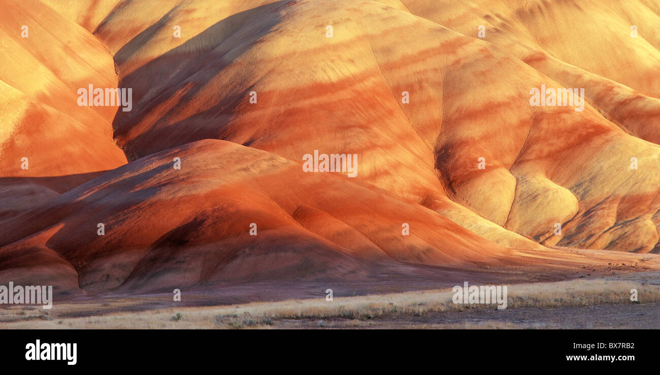 Striated badland hills at sunset, John Day Fossil Beds National ...