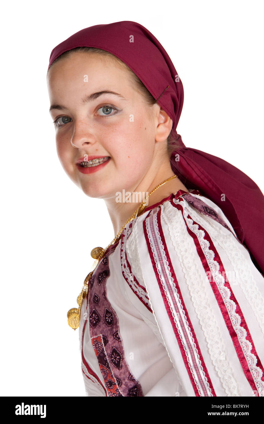 Studio shot of young girl in colourful Romanian national folk dancing ...