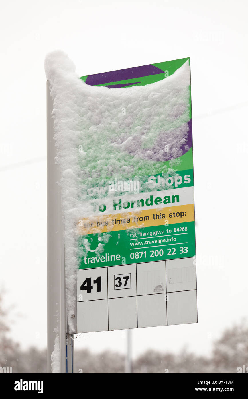 Bus stop sign partially obscured by snow Stock Photo - Alamy
