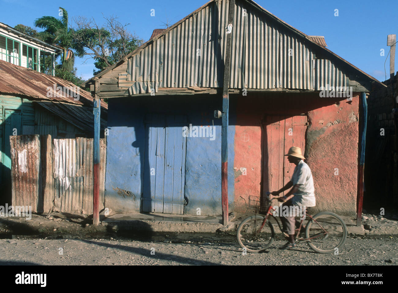 HAITI. MAN CYCLING IN PORT AU PRINCE Stock Photo - Alamy