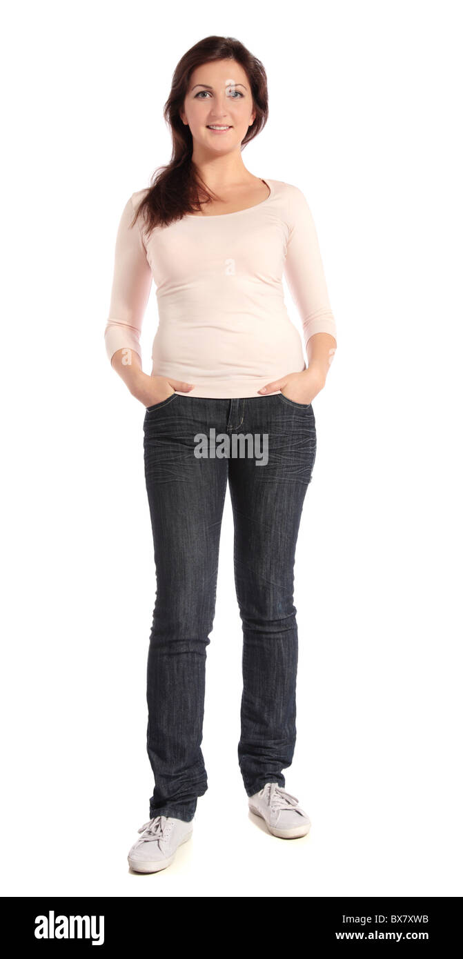 Attractive young woman standing in front off a plain white background ...