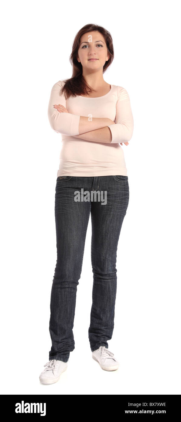 Attractive young woman standing in front off a plain white background ...