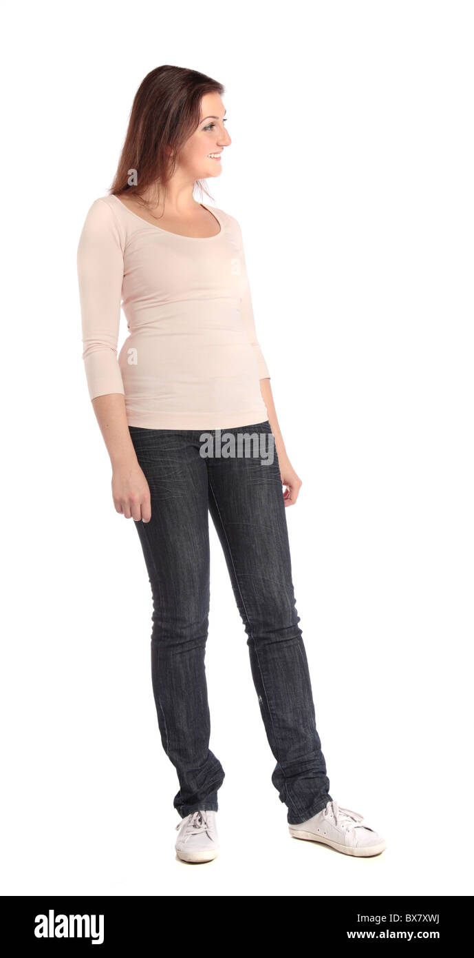 Attractive young woman standing in front off a plain white background ...