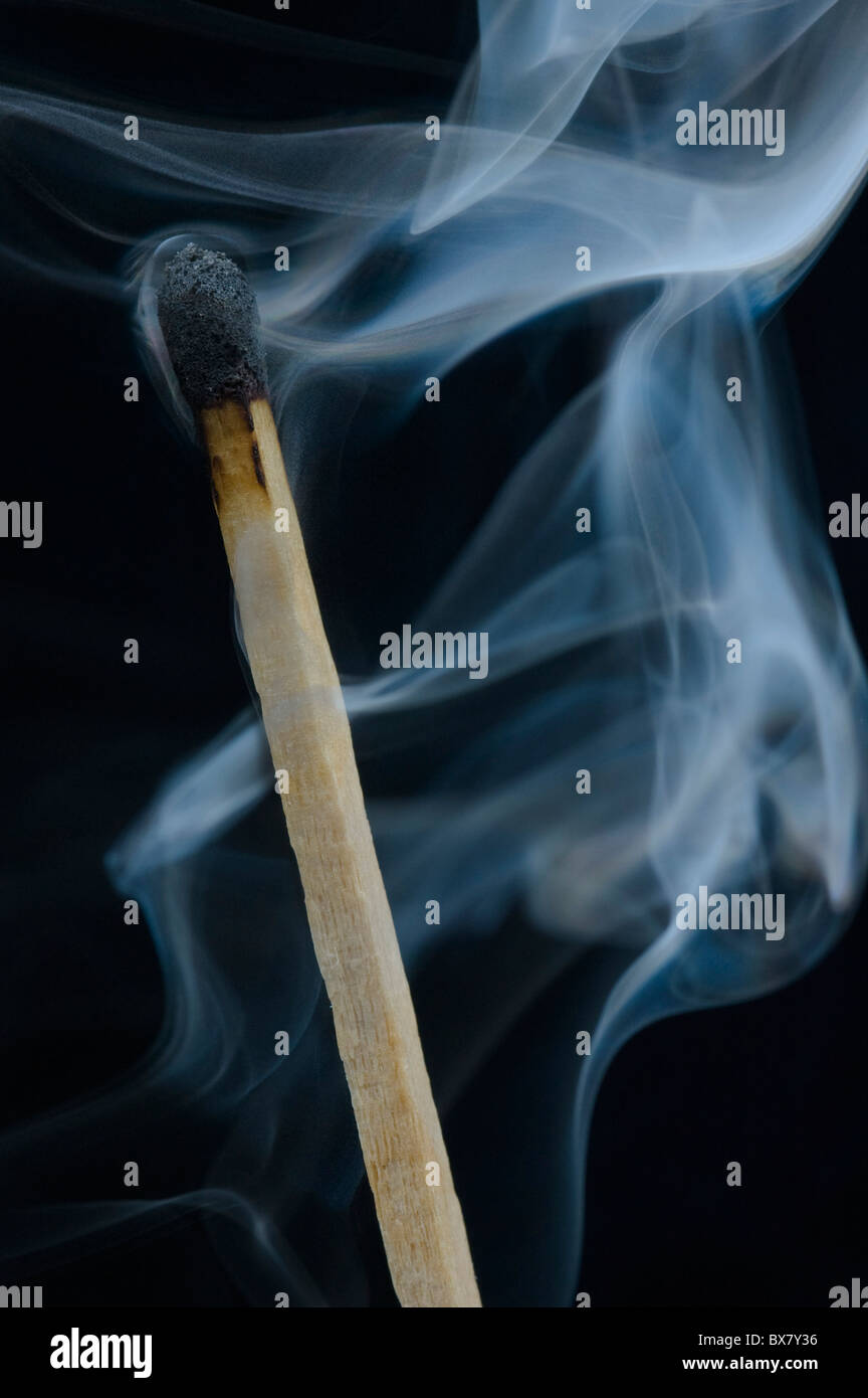 An ordinary household safety match - smoking, on black Stock Photo - Alamy