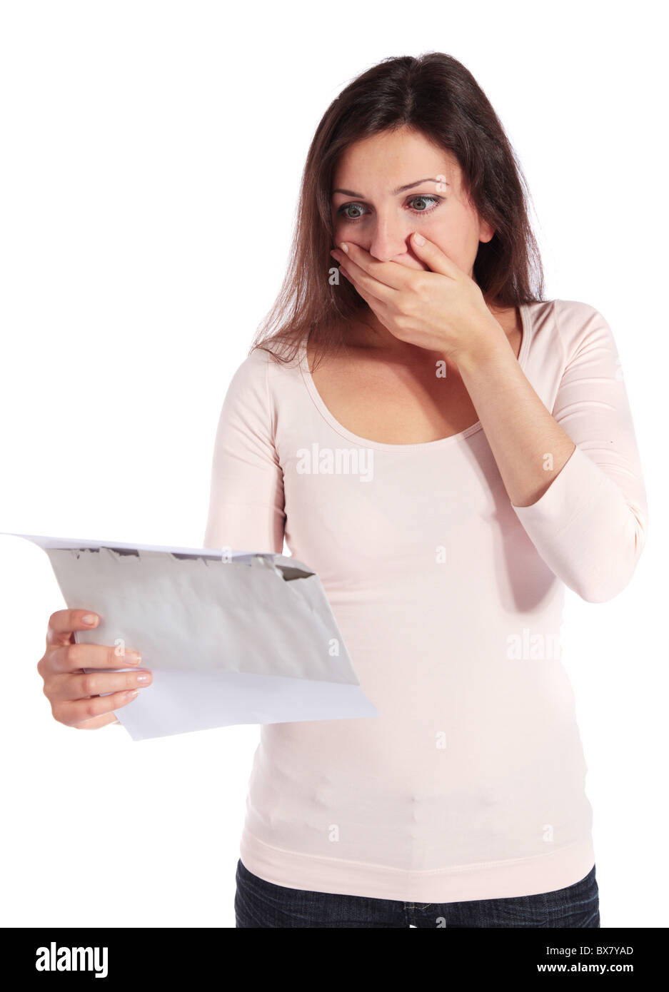 Attractive young woman gets bad news via mail. All isolated on white ...