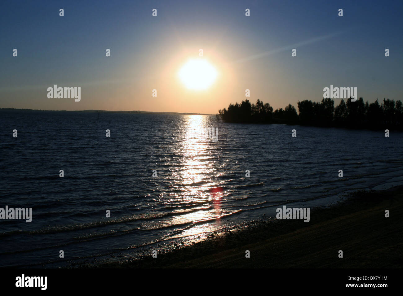 Sunset over Misty Bay Stock Photo - Alamy