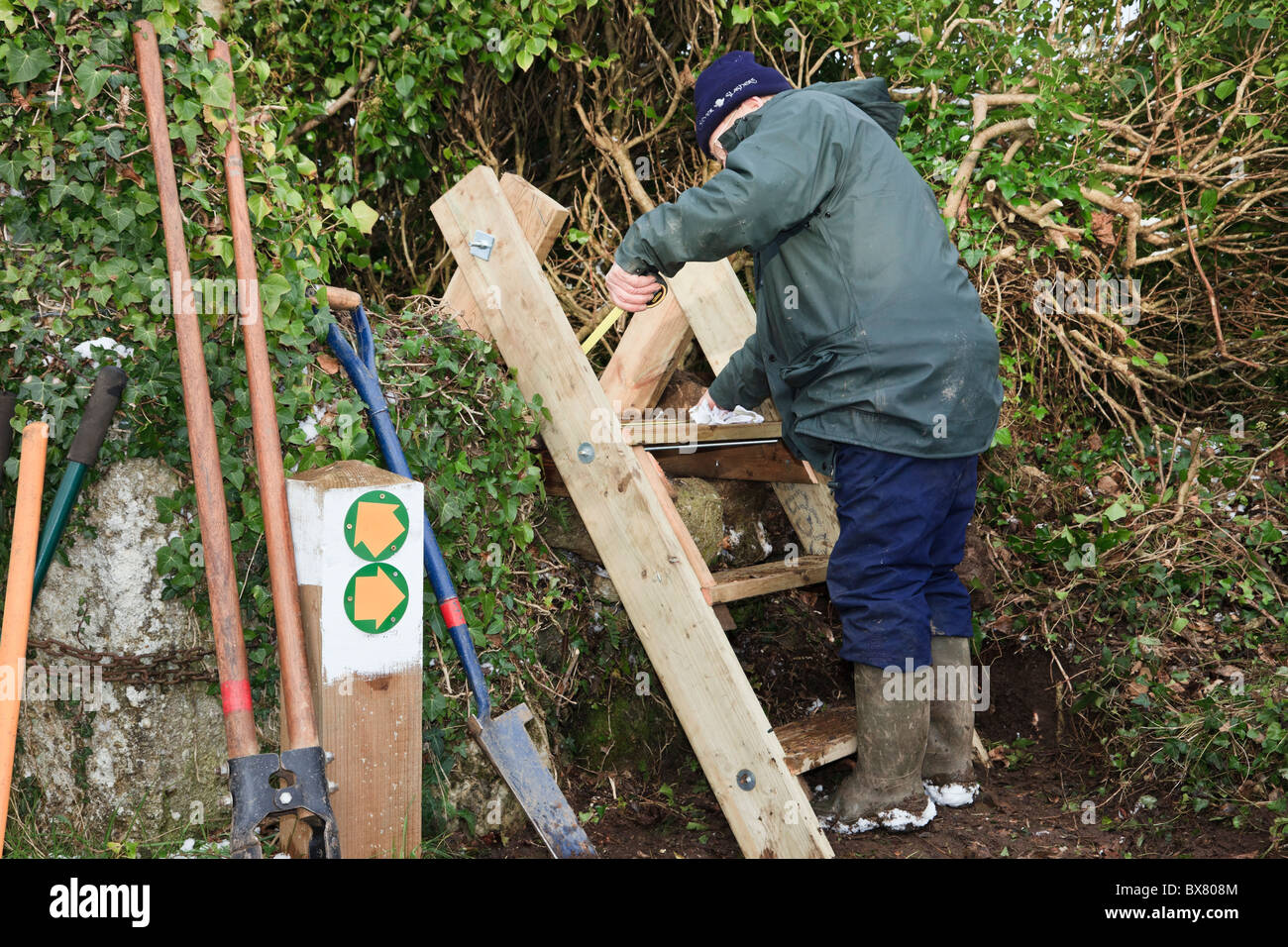 UK. Ramblers volunteer building a ladder stile and clearing a public ...