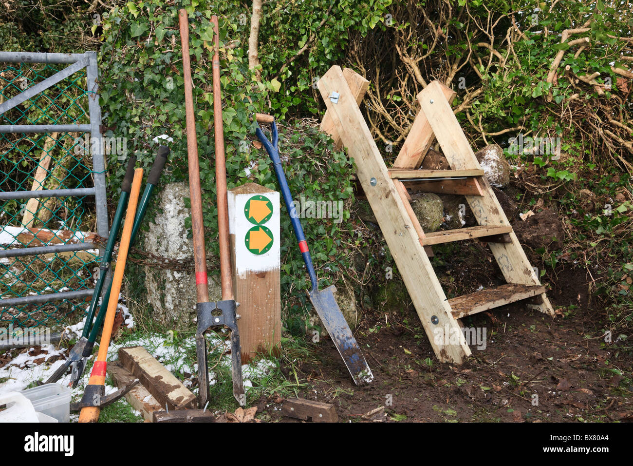 UK, Europe. New ladder stile waymarker and tools on a country footpath ...