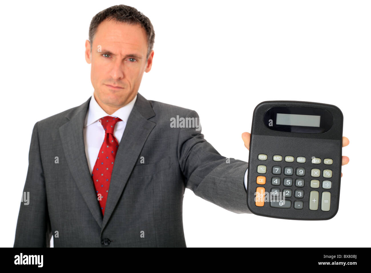 Serious businessman holding a calculator. All on white background Stock ...