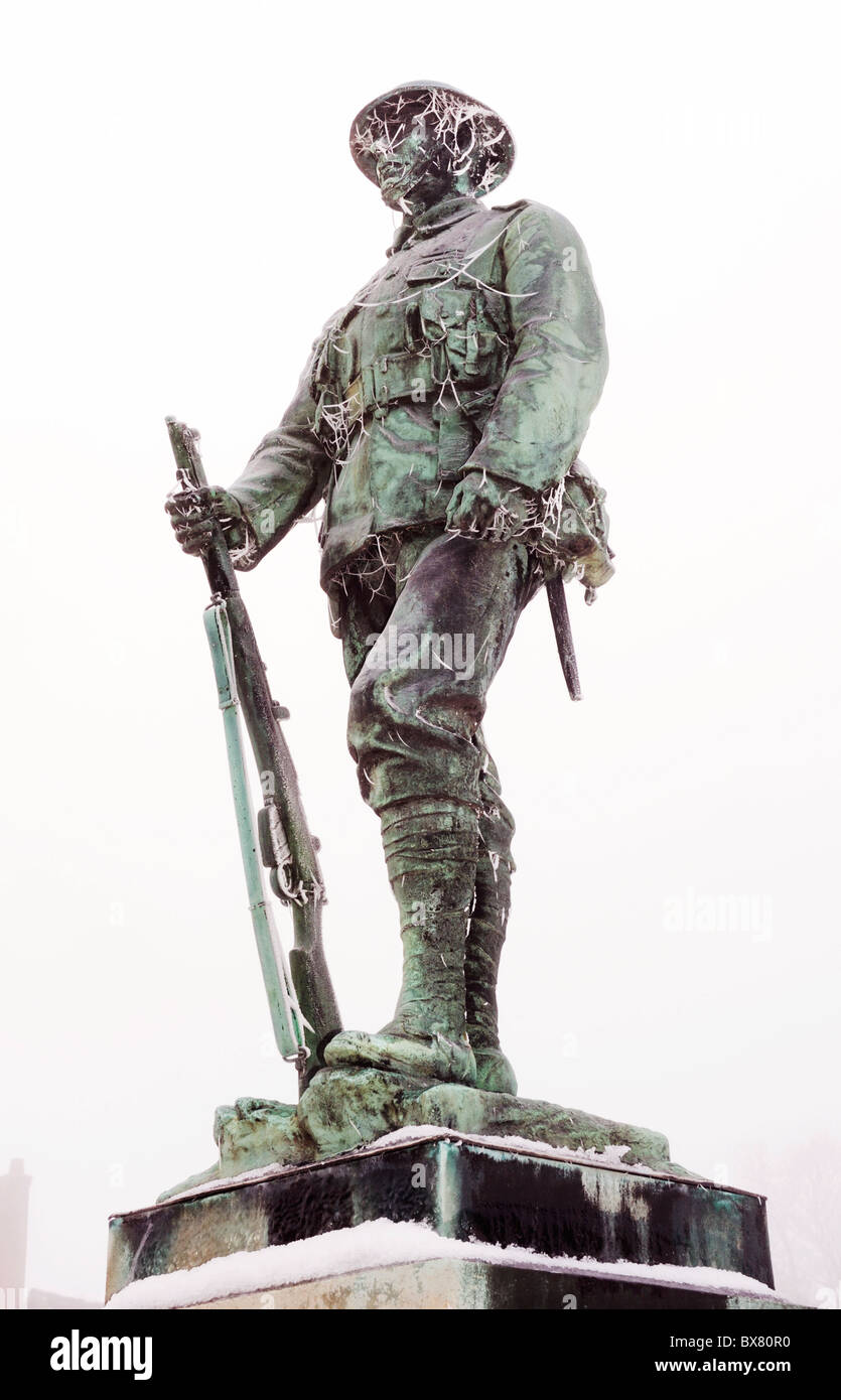 War memorial with world war one British soldier with ice covering on ...