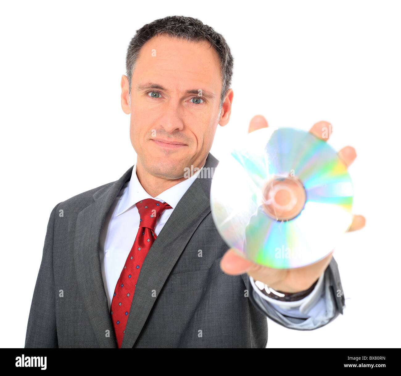 Attractive businessman holding dvd. All on white background Stock Photo ...