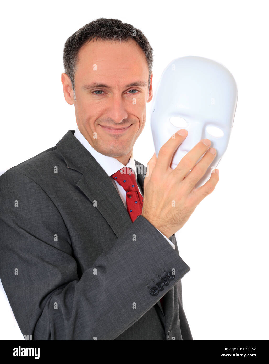Attractive businessman reveals his face behind a mask. All on white ...