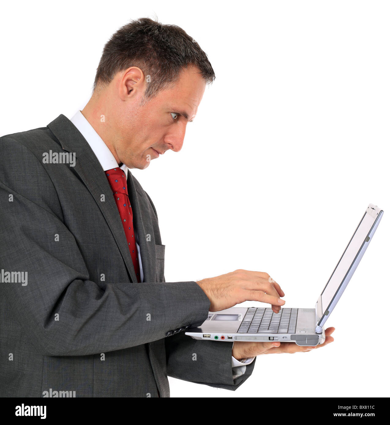 Attractive businessman using notebook computer. All on white background ...
