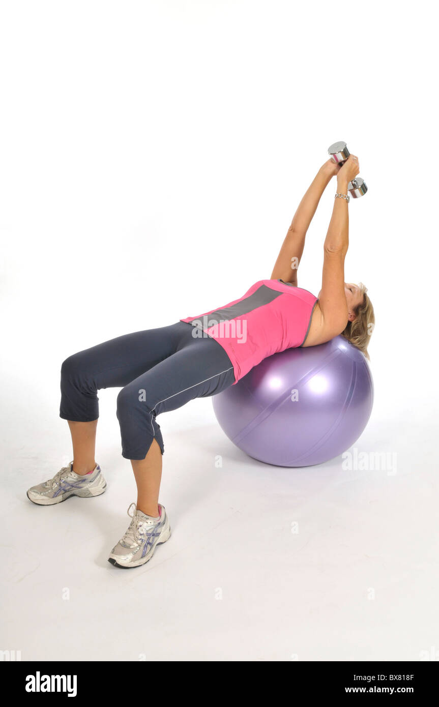 stability rotation on ball with dumb bell Stock Photo - Alamy