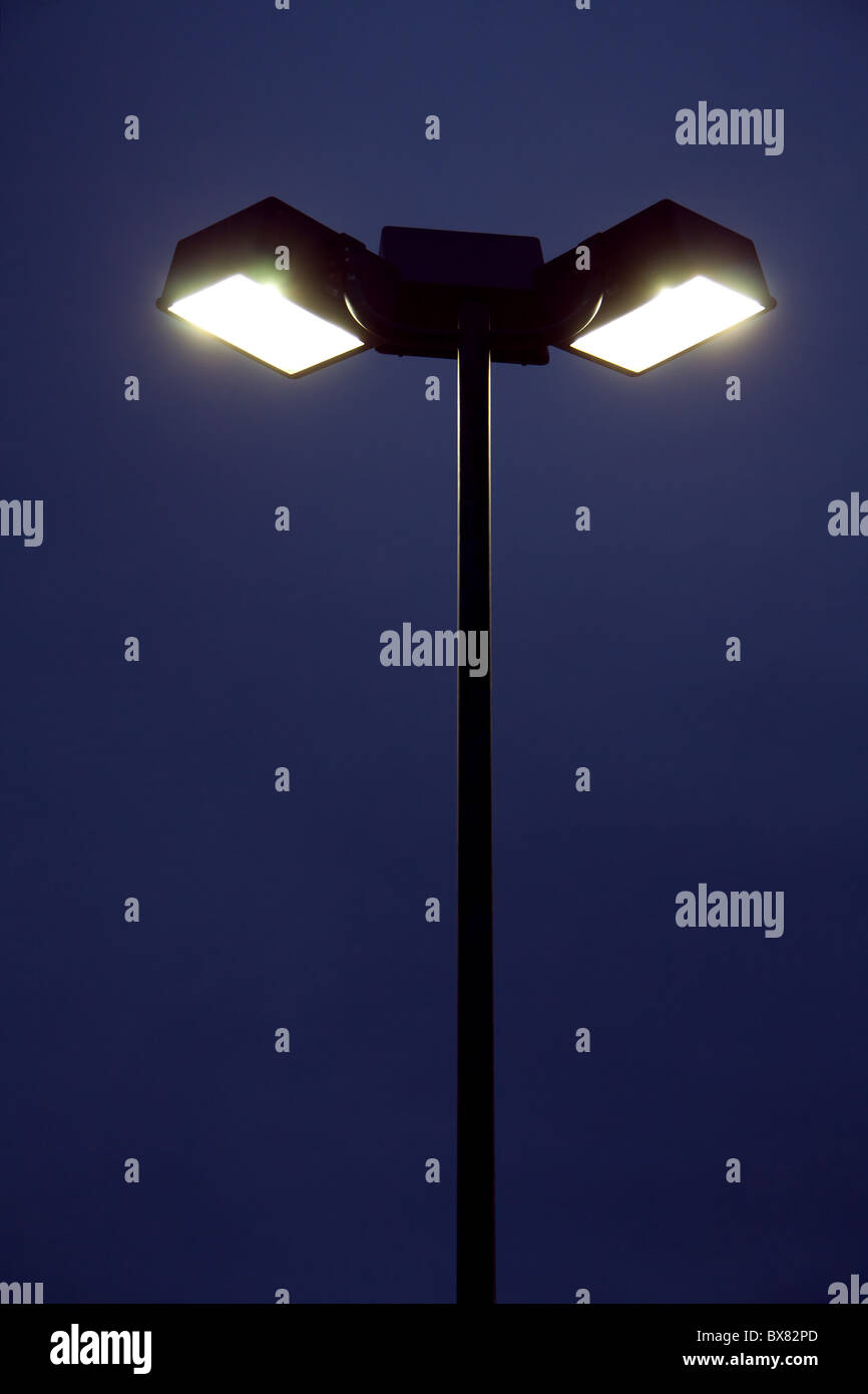 Illuminated halogen street light at night with dark background Stock ...