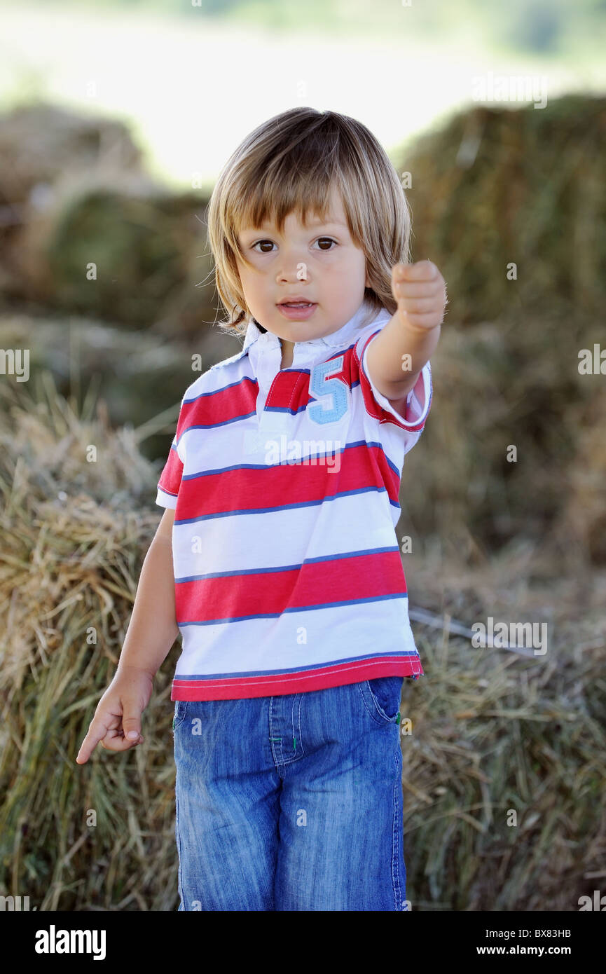 little boy with his hand raised Stock Photo - Alamy
