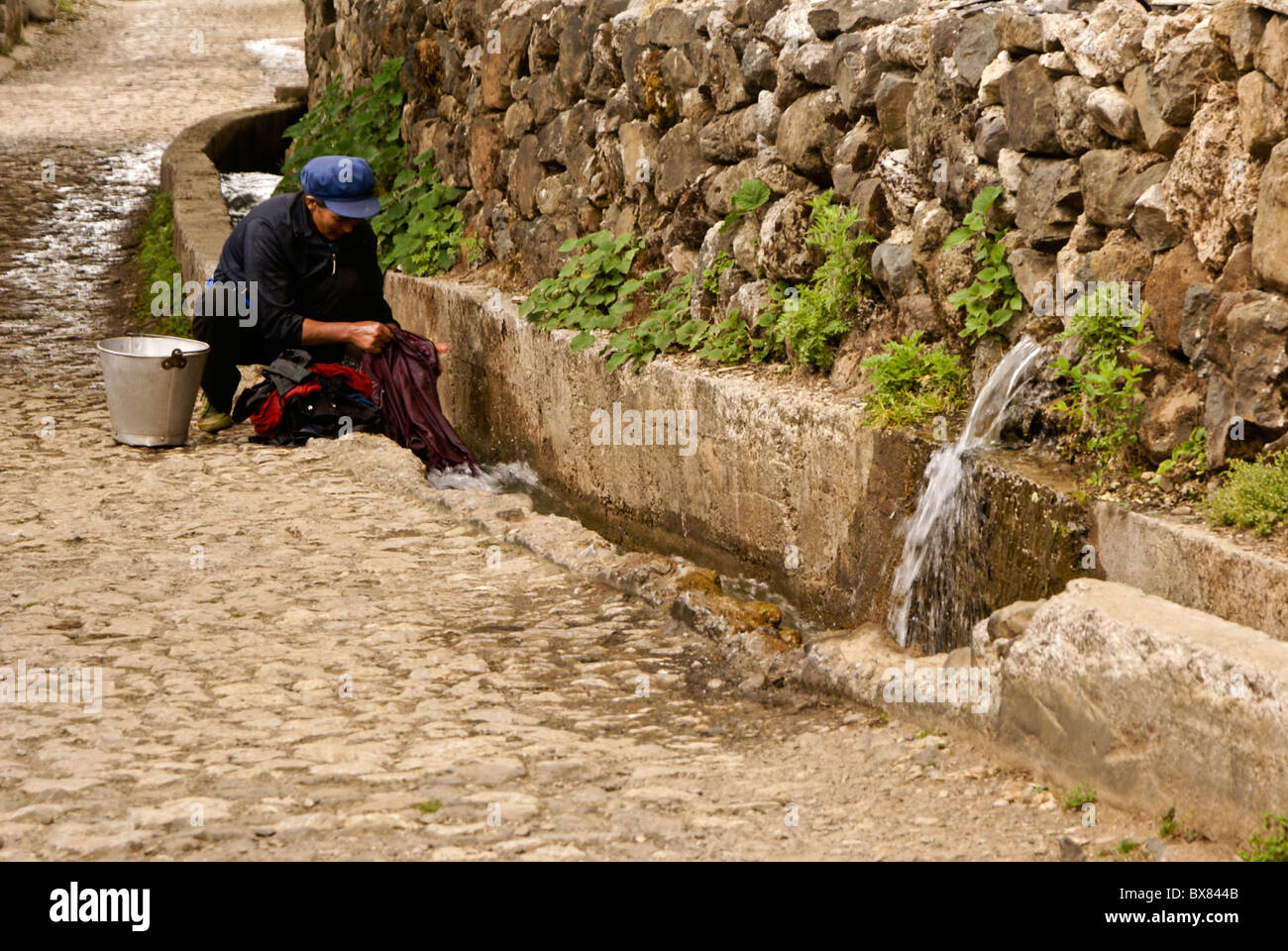 Naxi woman washing clothes in village of Yuhu, Lijiang, Yunnan, China ...