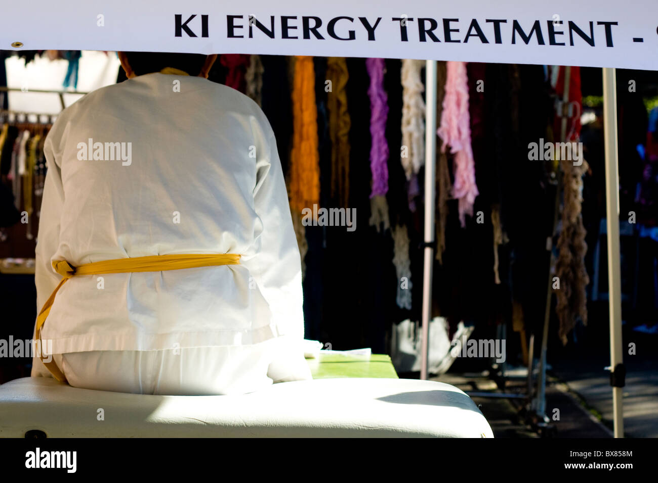 A Ki Energy practitioner waits for customers at Glebe Markets in Sydney ...