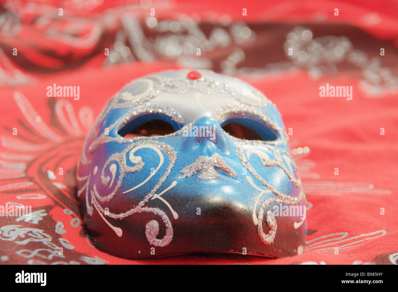 Theatrical mask against a fan lying on a table Stock Photo - Alamy