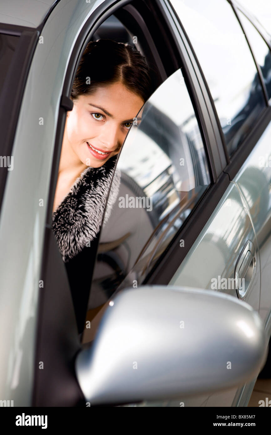 Portrait of vivid brunette looking with interest through the window of ...