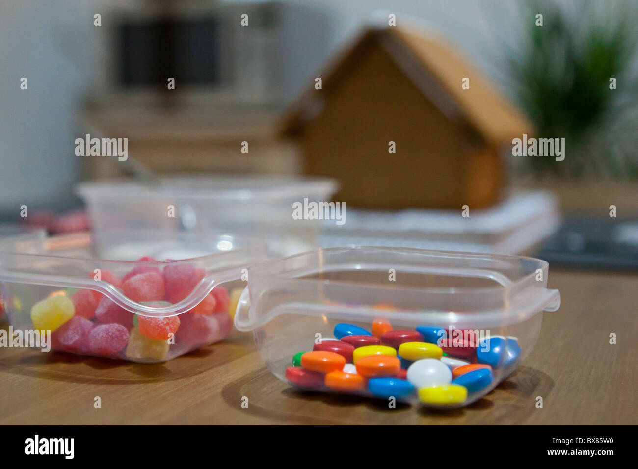 Gingerbread house being built, with candies in the foreground Stock ...