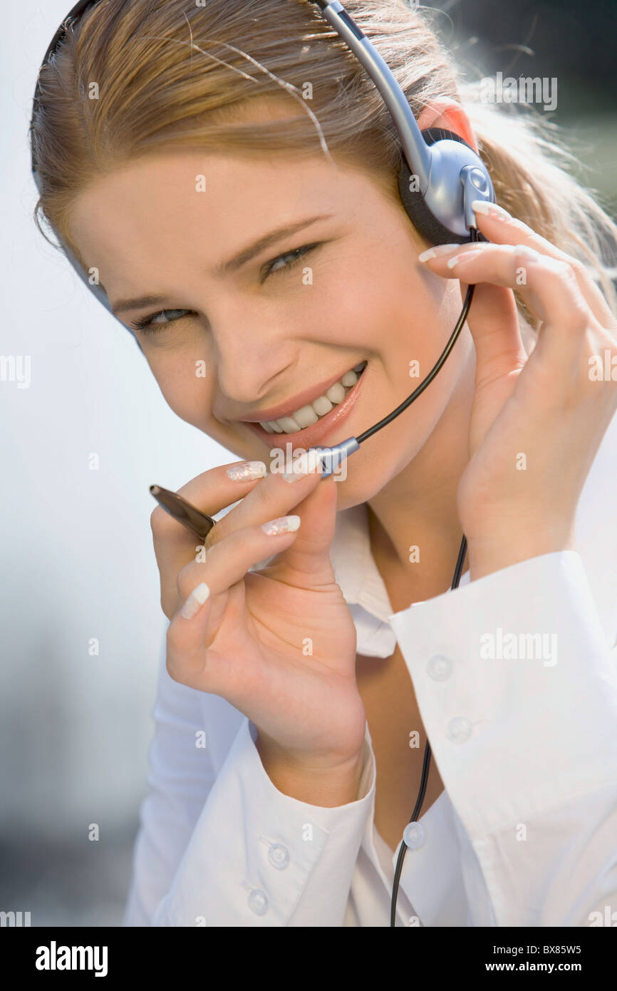 Portrait of friendly telephone operator smiling during a telephone conversation Stock Photo - Alamy