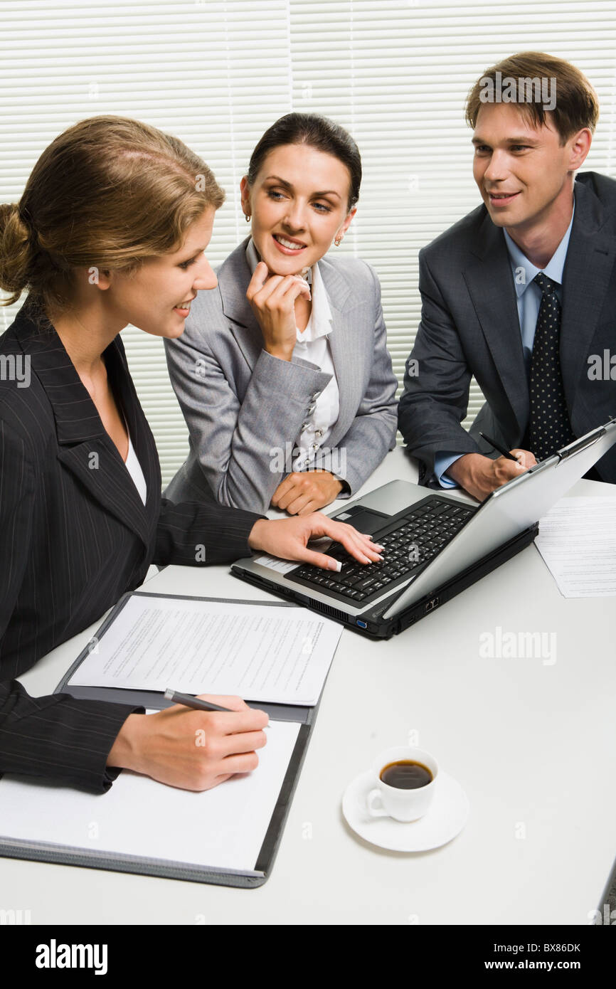 Young woman answers questions at presence of the manager and the boss ...