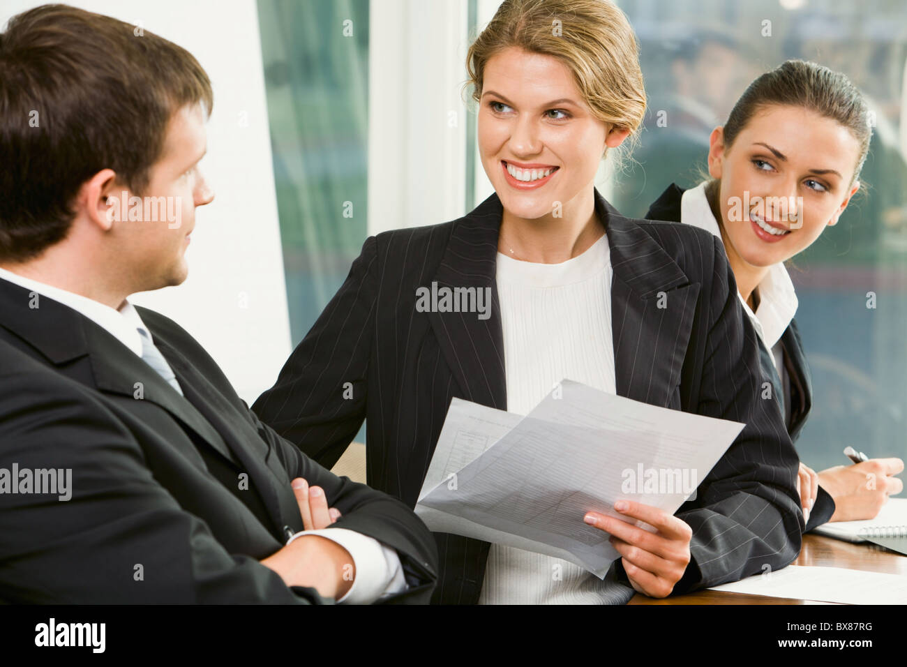 Successful assistant is holding contract and showing to her chief in ...