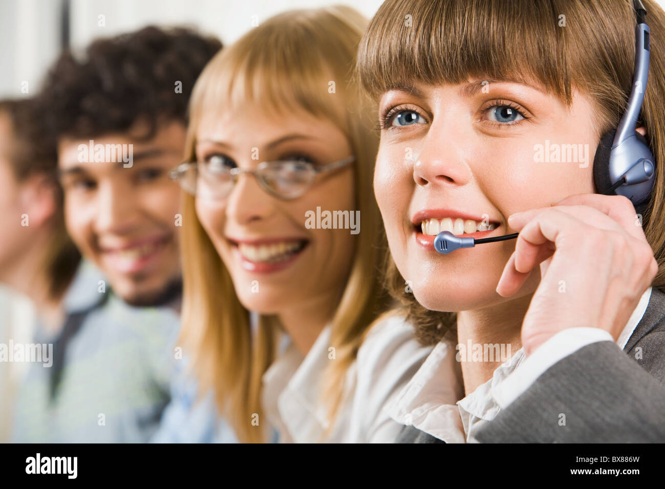 A friendly smiling customer support operator on a background of three ...