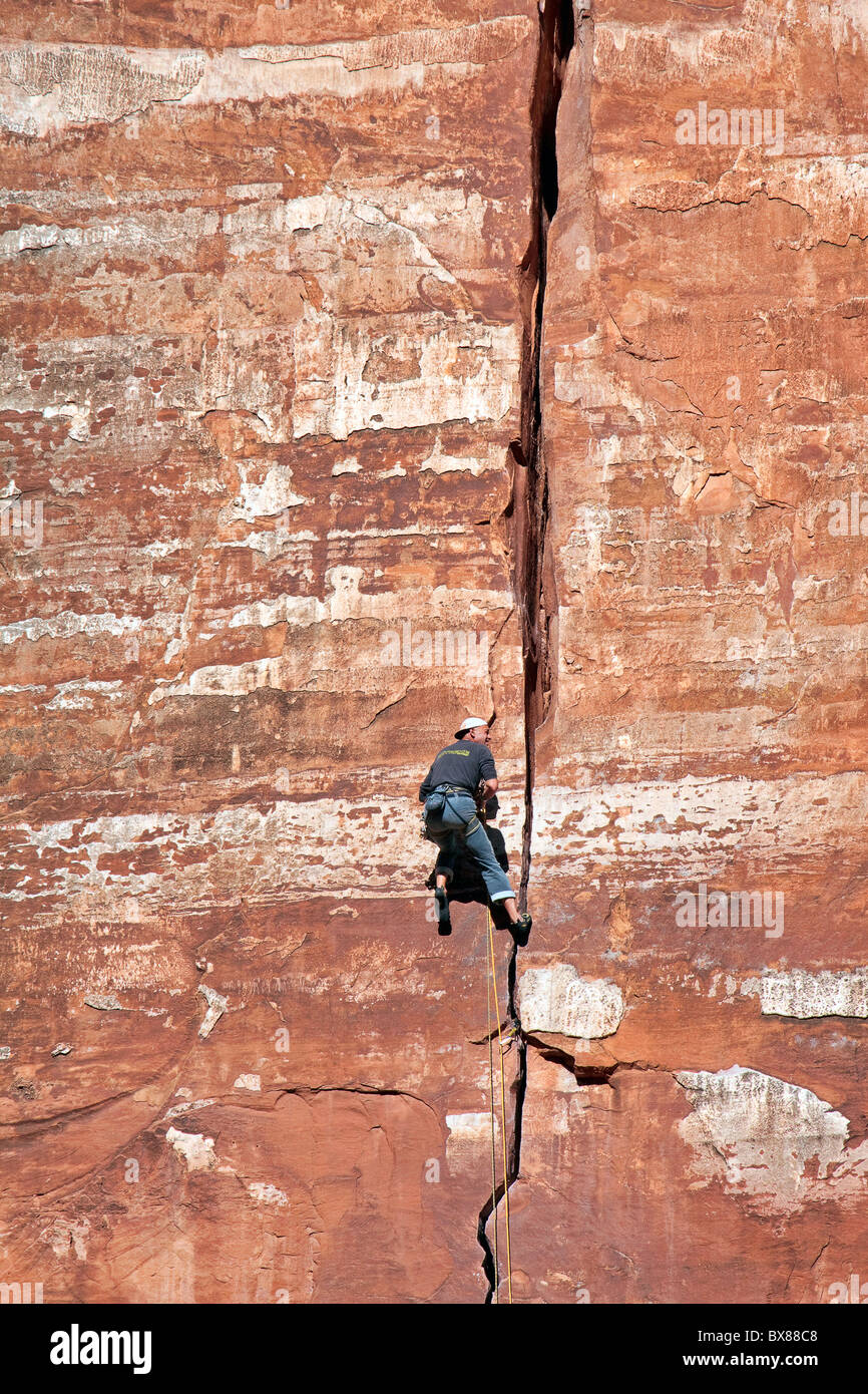 Man climbing sheer rock face in Zion National Park Stock Photo - Alamy