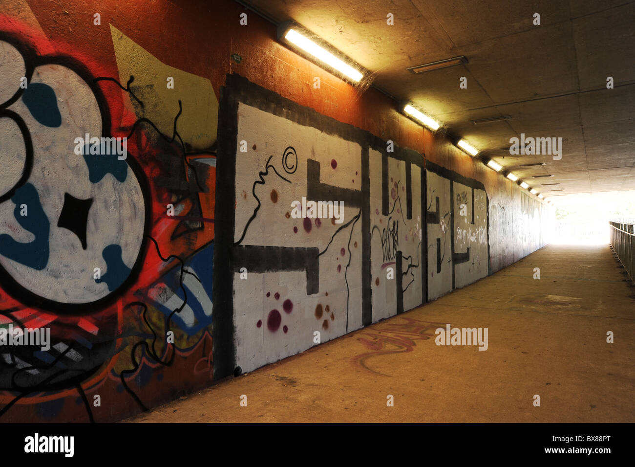 Brightly coloured graffiti art sprayed on a wall of an underpass Stock ...