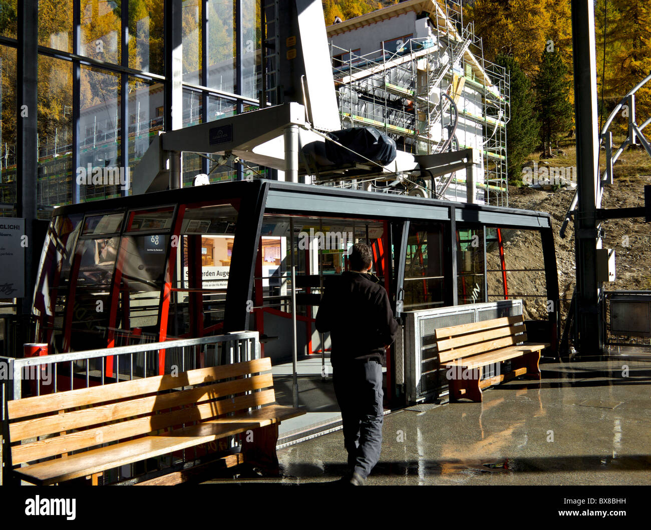 Man boarding aerial cable tram gondola car station Mount Corvatsch St ...